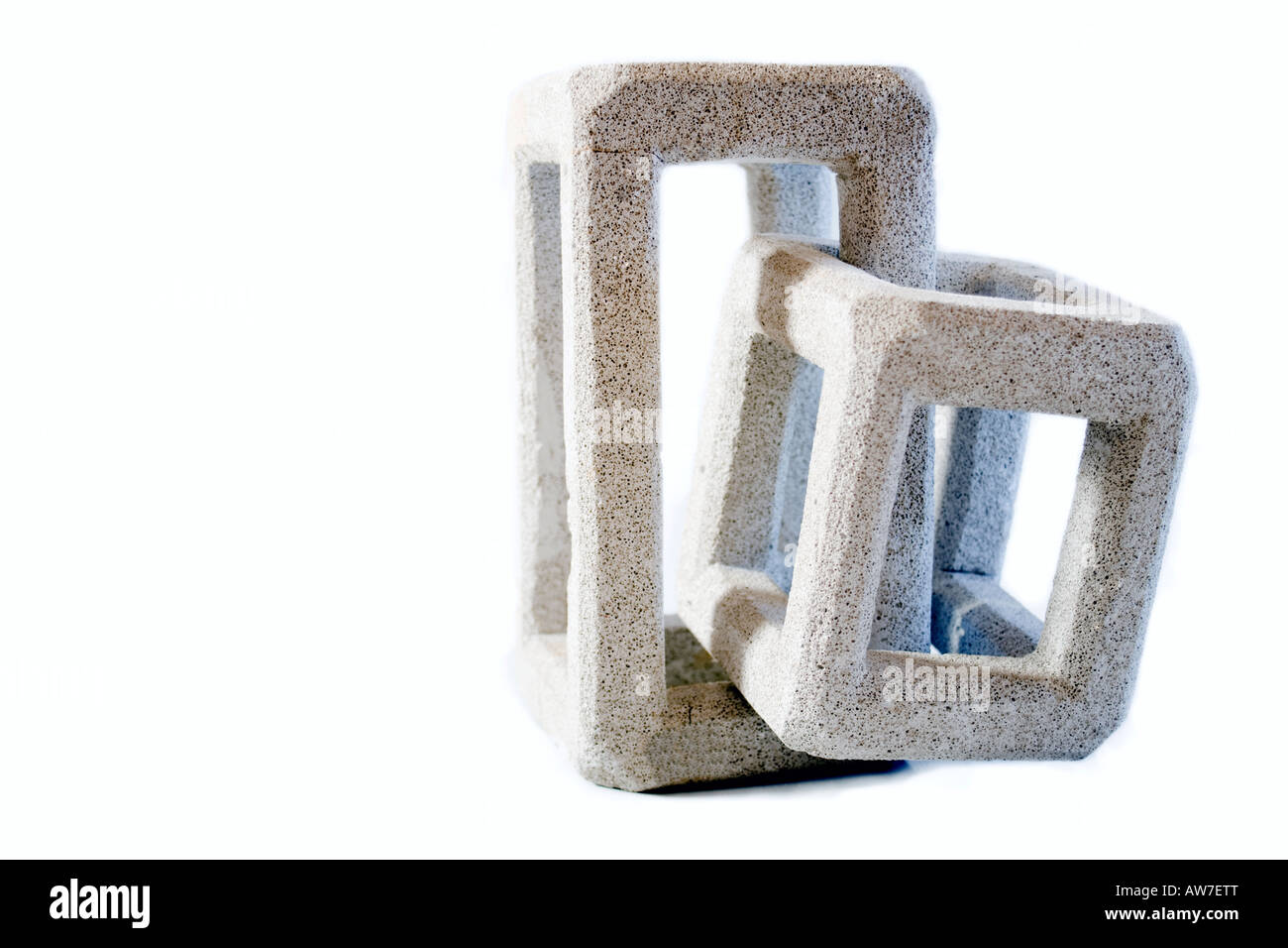 Two piece of intermingled concrete puzzle on a white background ...