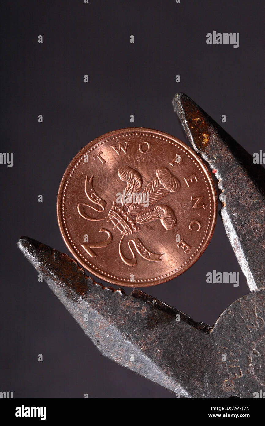 British money 2p 2 pence copper coin being held squeeze by plier tool ...