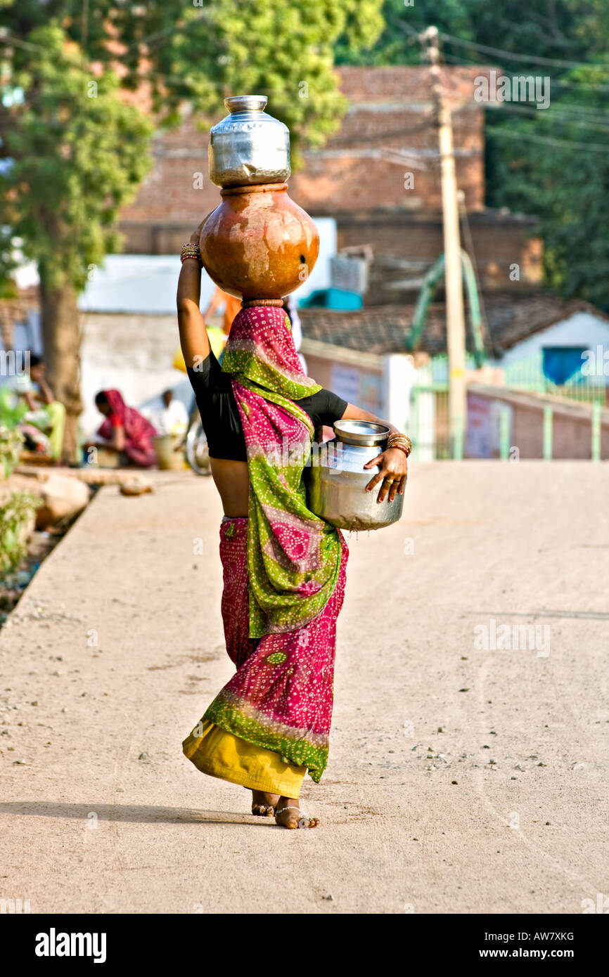 Indian woman walking with water recipient, Orchha, India Stock Photo ...