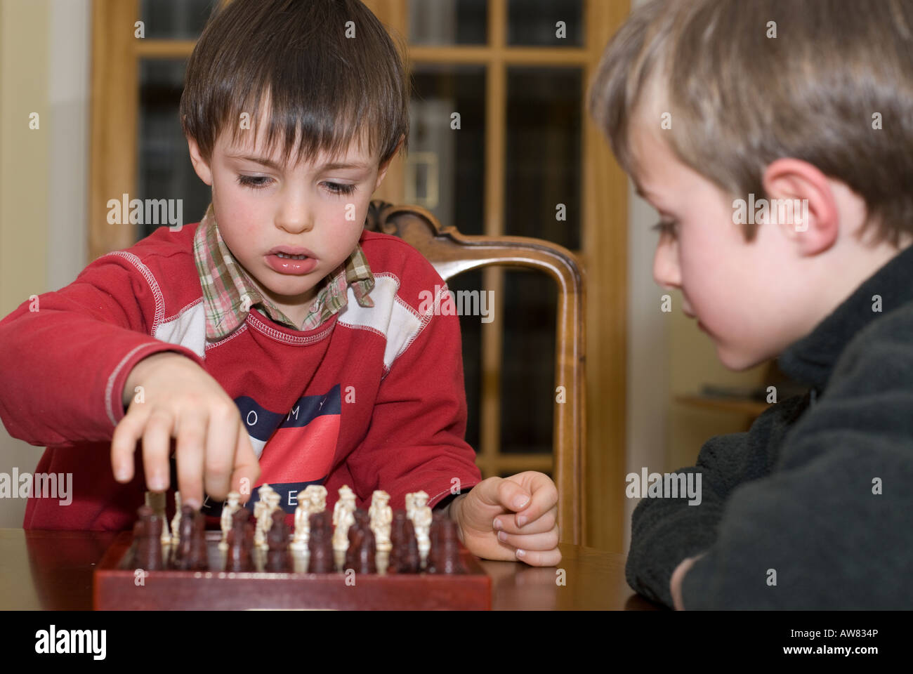 Boys playing chess Stock Photo - Alamy