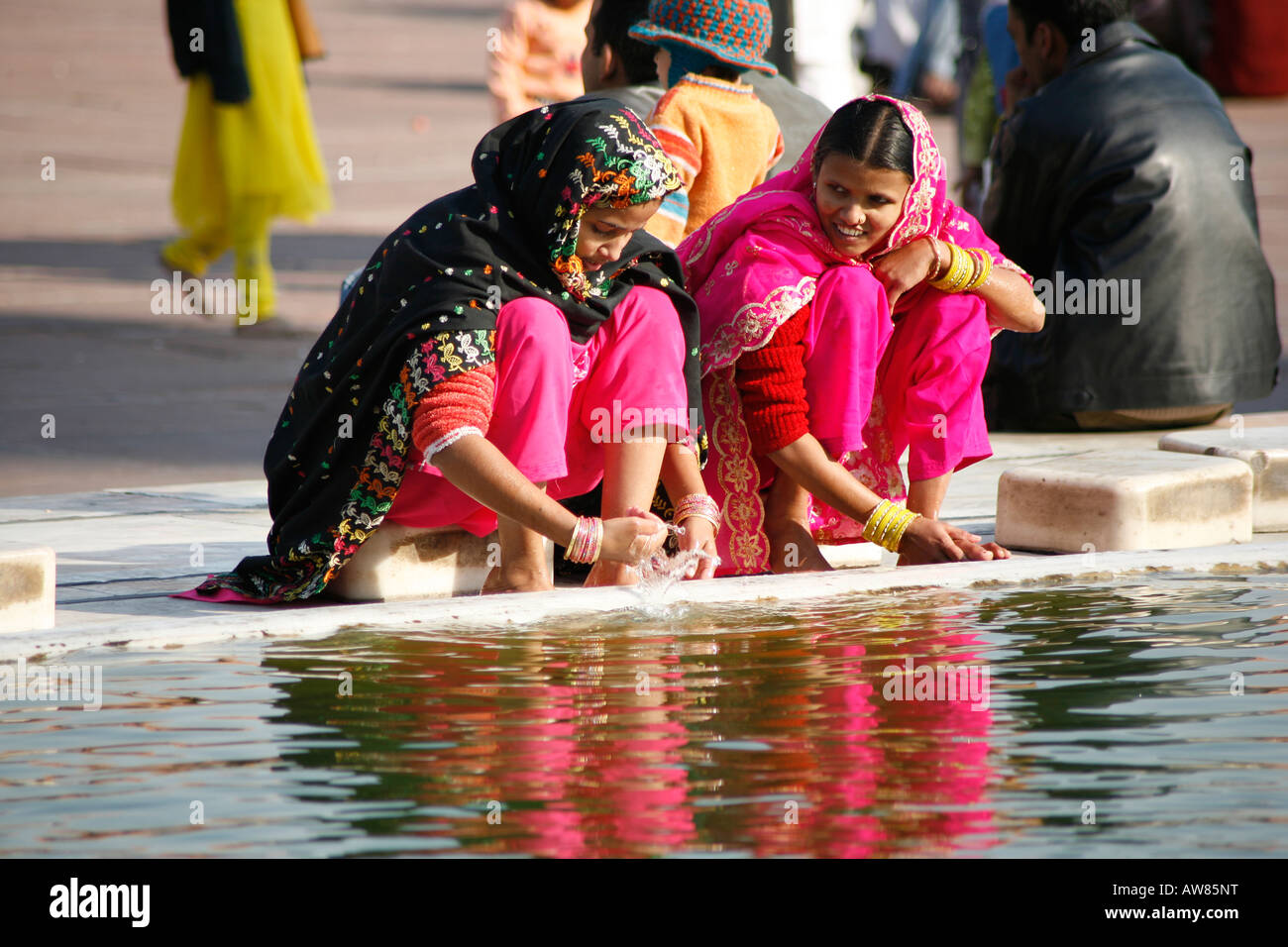 Women in saris performing ablution at Jama Masjid Delhi India Stock ...