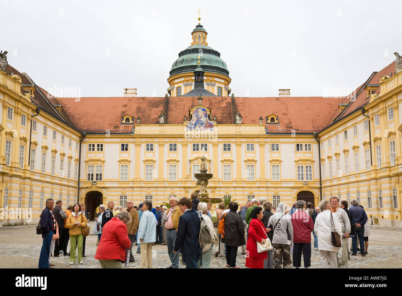 Tourists standing in the courtyard of the baroque benedictine monastery ...