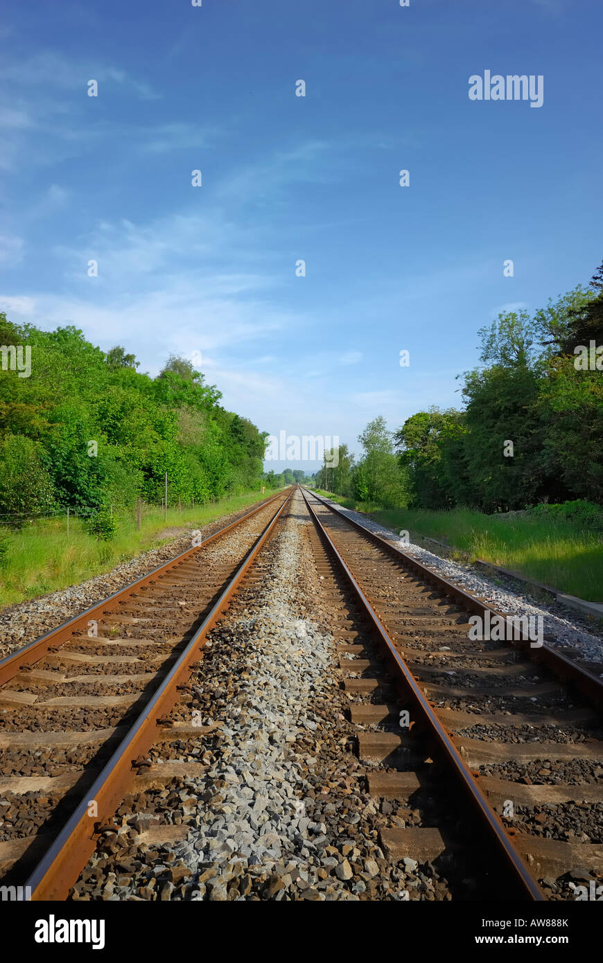 A pair of railway tracks converging into the distance Stock Photo - Alamy