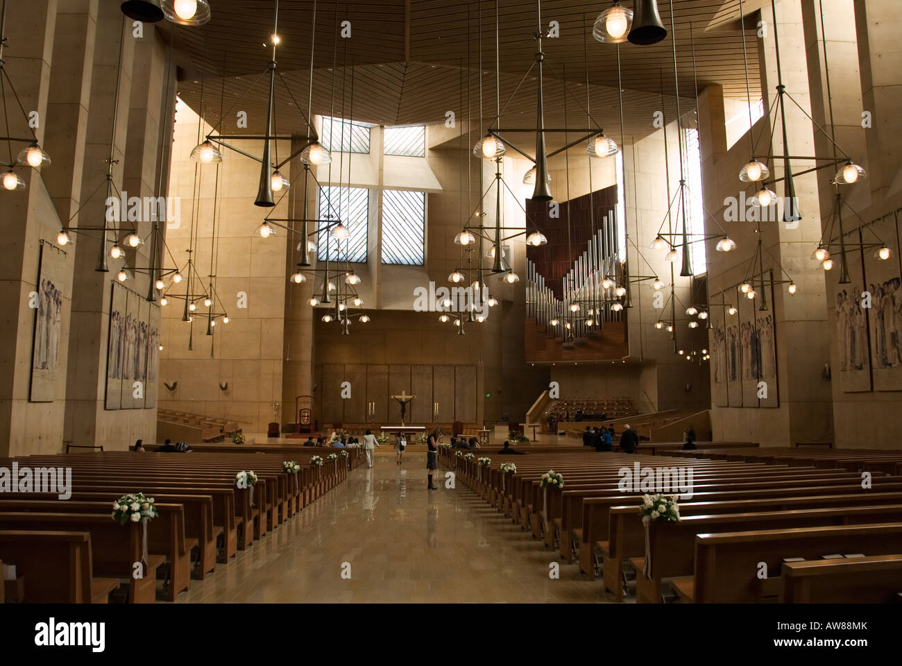People in the interior of a very large church with high ceilings just ...