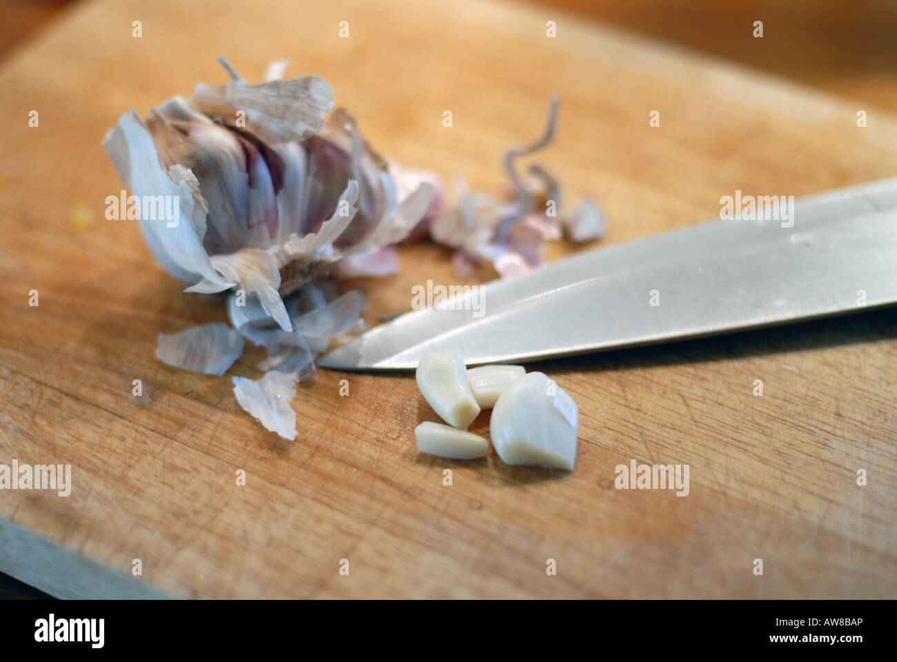 Chopping Garlic whilst preparing a meal Stock Photo - Alamy