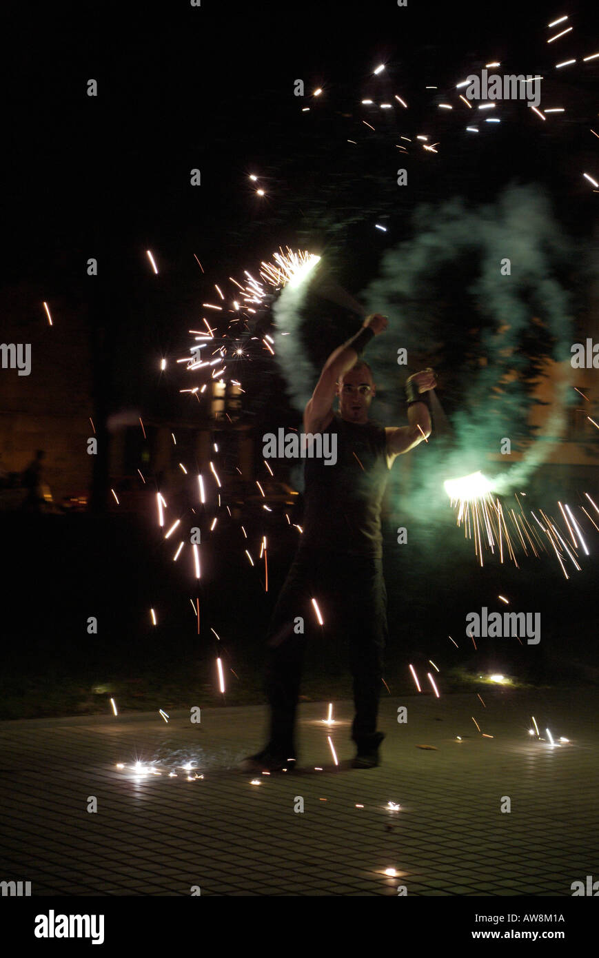Street Performer Juggles Sticks of Fire at Night Stock Photo - Alamy