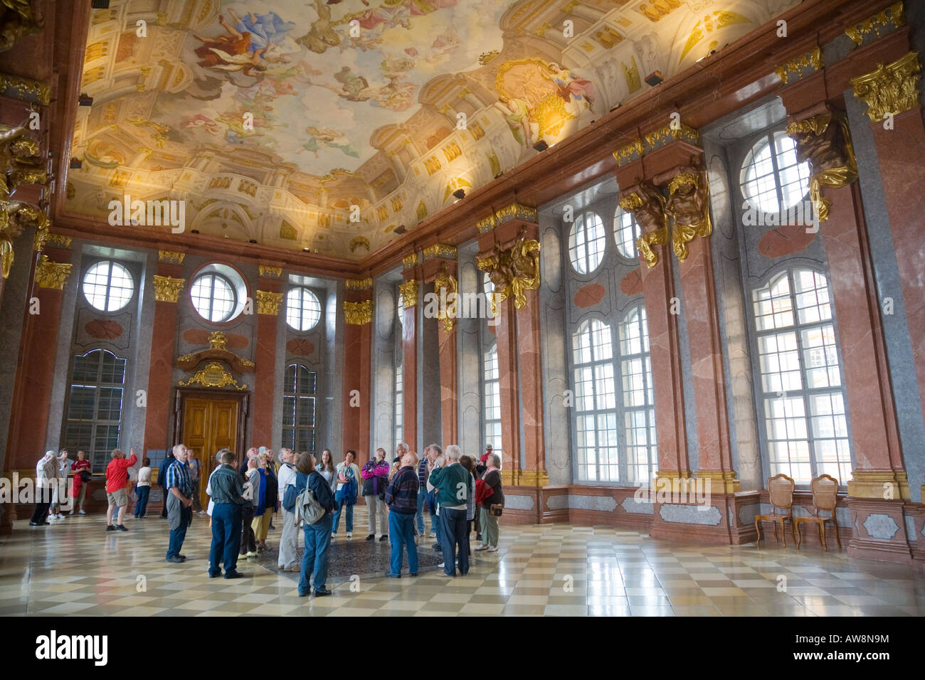 Tourists visiting the marble hall inside the baroque benedictine ...