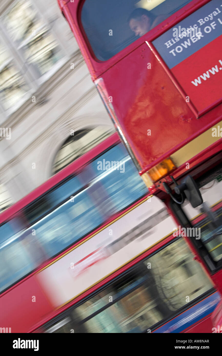 Speeding London buses passing each other along a busy road Stock Photo ...