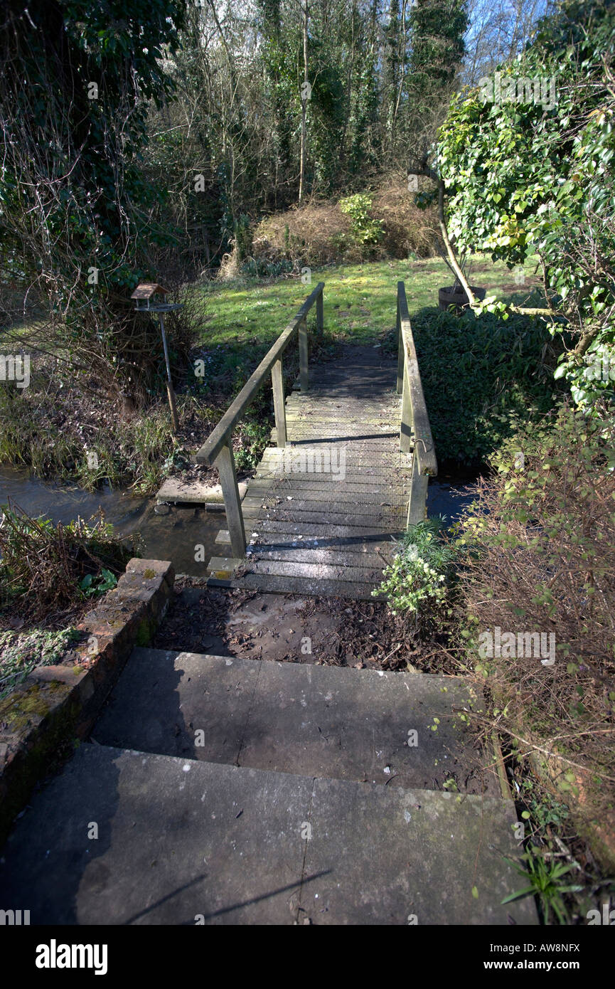 garden bridge over stream green vegetation footbridge Stock Photo - Alamy