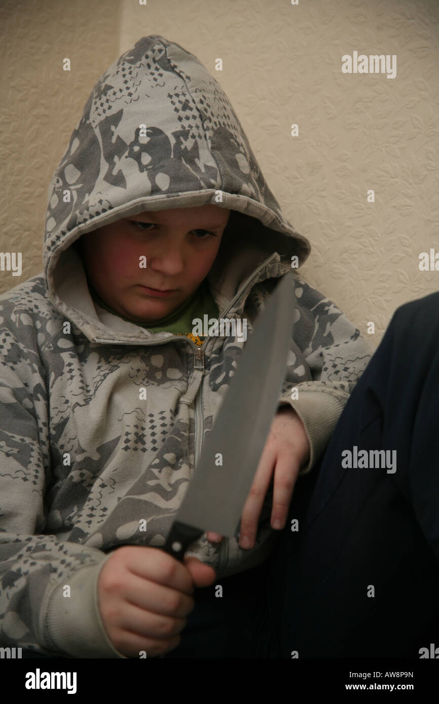 Hooded boy with a knife Stock Photo - Alamy