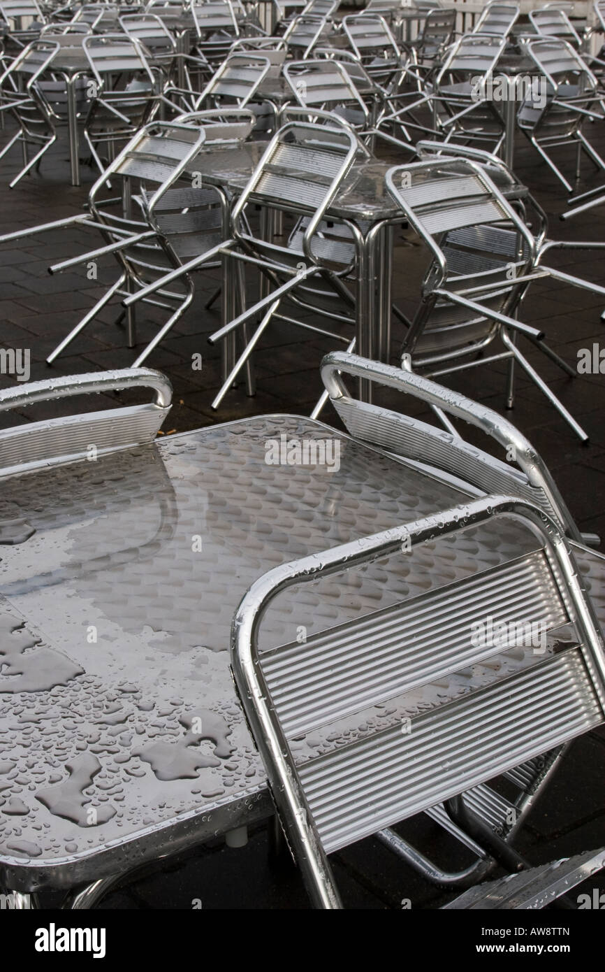 Chairs stacked in the rain at an outside cafe Stock Photo - Alamy