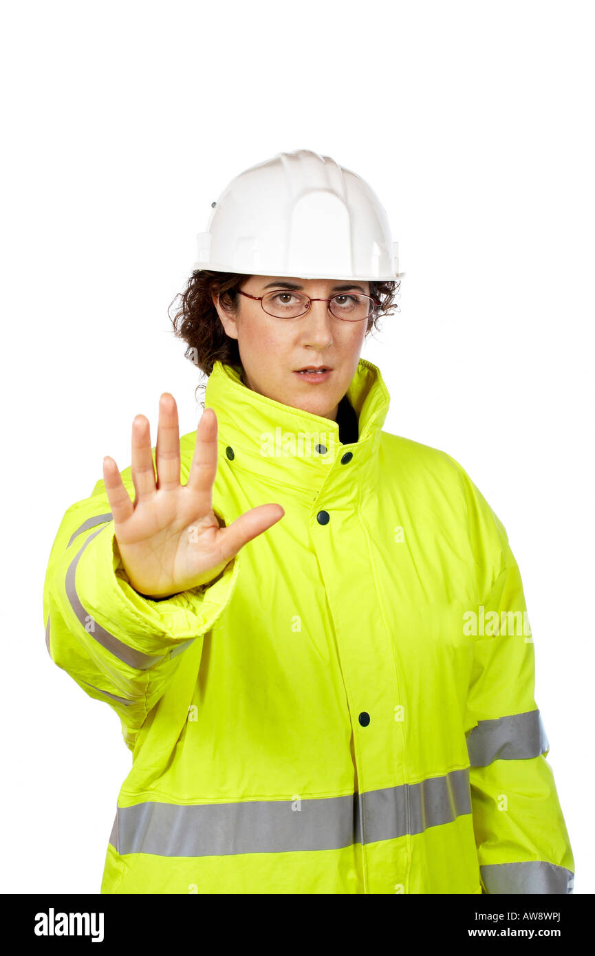 Serious female construction worker saying stop over a white background ...