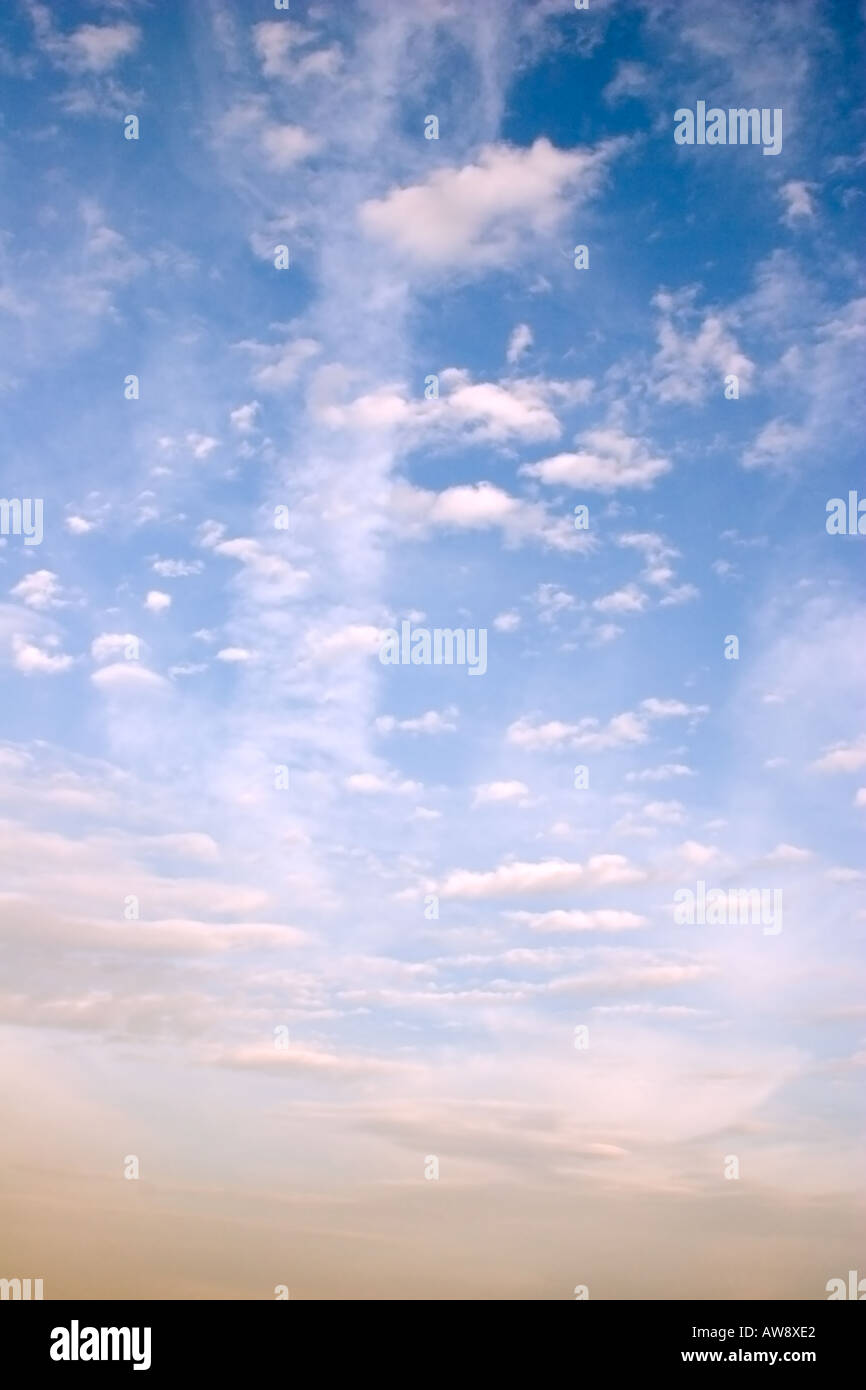 light and airy cloud formation against blue and yellow sky Stock Photo ...