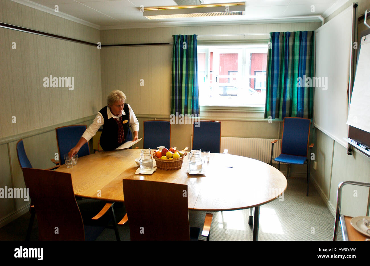 Conference hostess cleaning a conference table after a meeting Stock ...