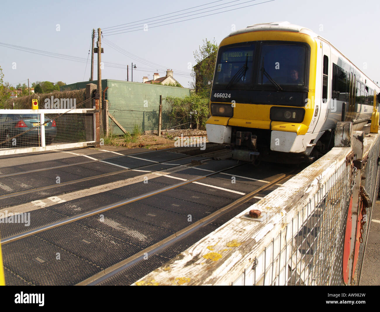 front modern commuter train passing level crossing Stock Photo - Alamy