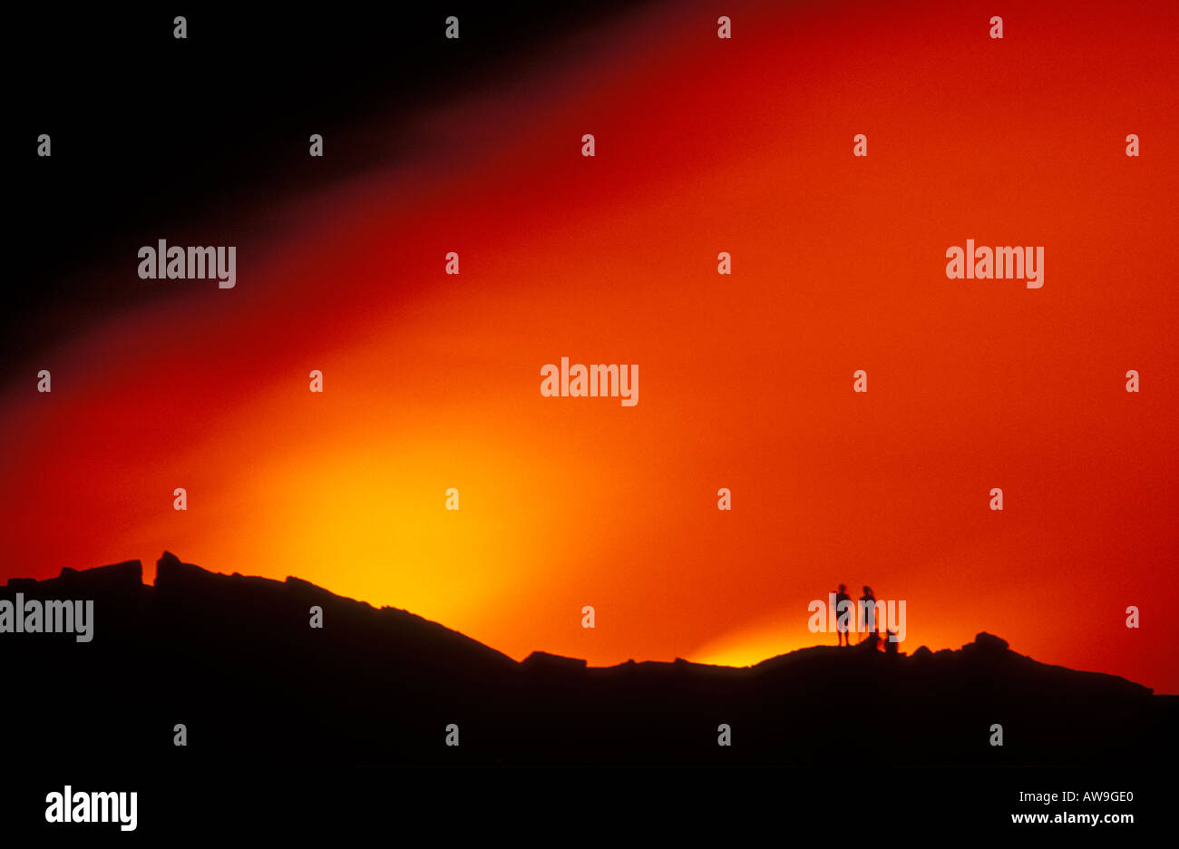 Lava flow entering the Pacific Ocean at night (silhouetted spectators visible) Hawaii Volcanoes ...
