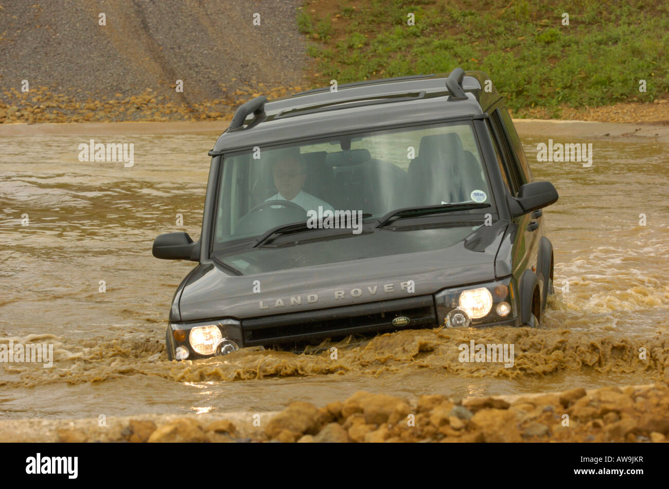 Land Rover Discovery negotiating a water hazard Stock Photo - Alamy