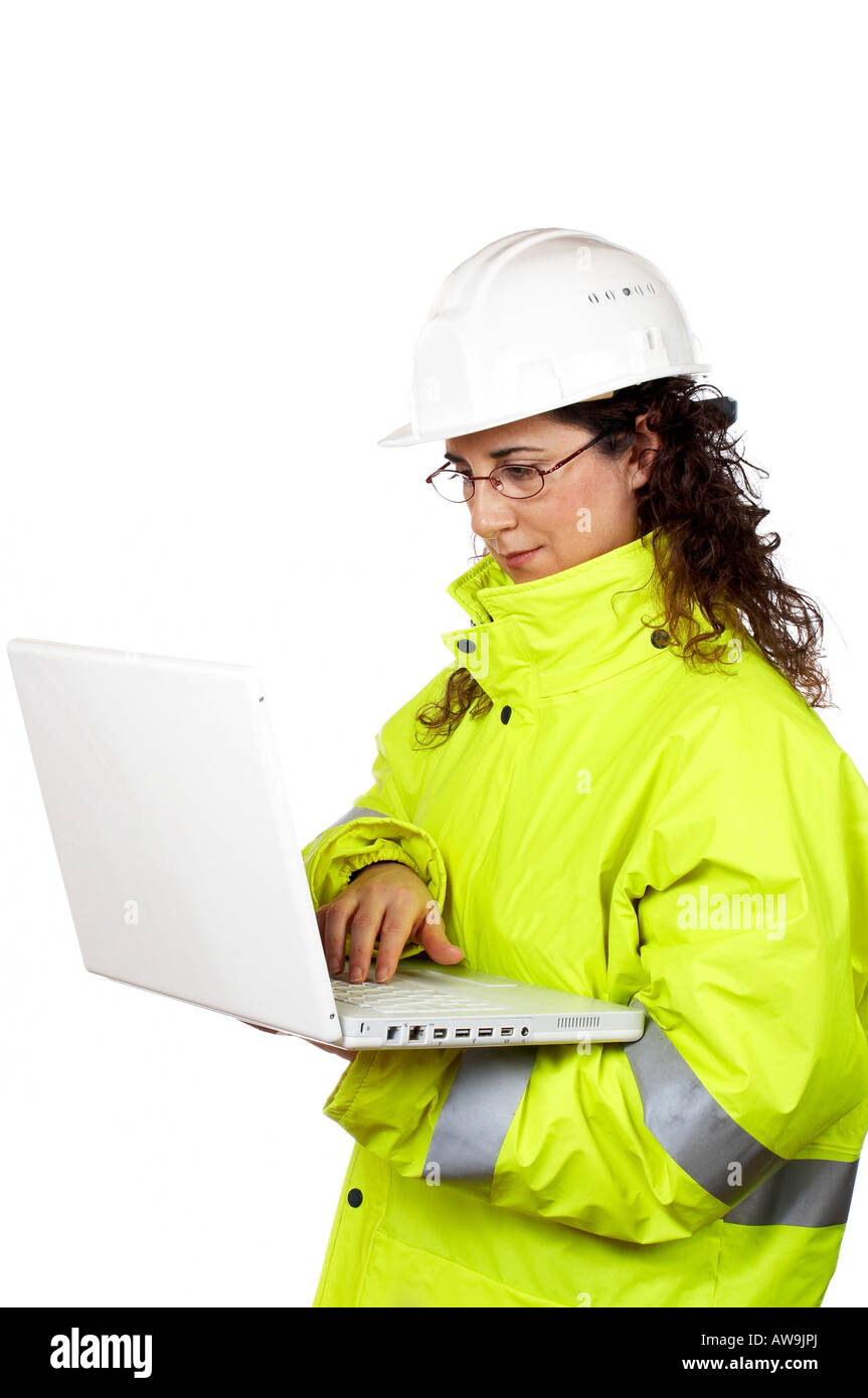 Female construction worker write in a laptop over a white background ...