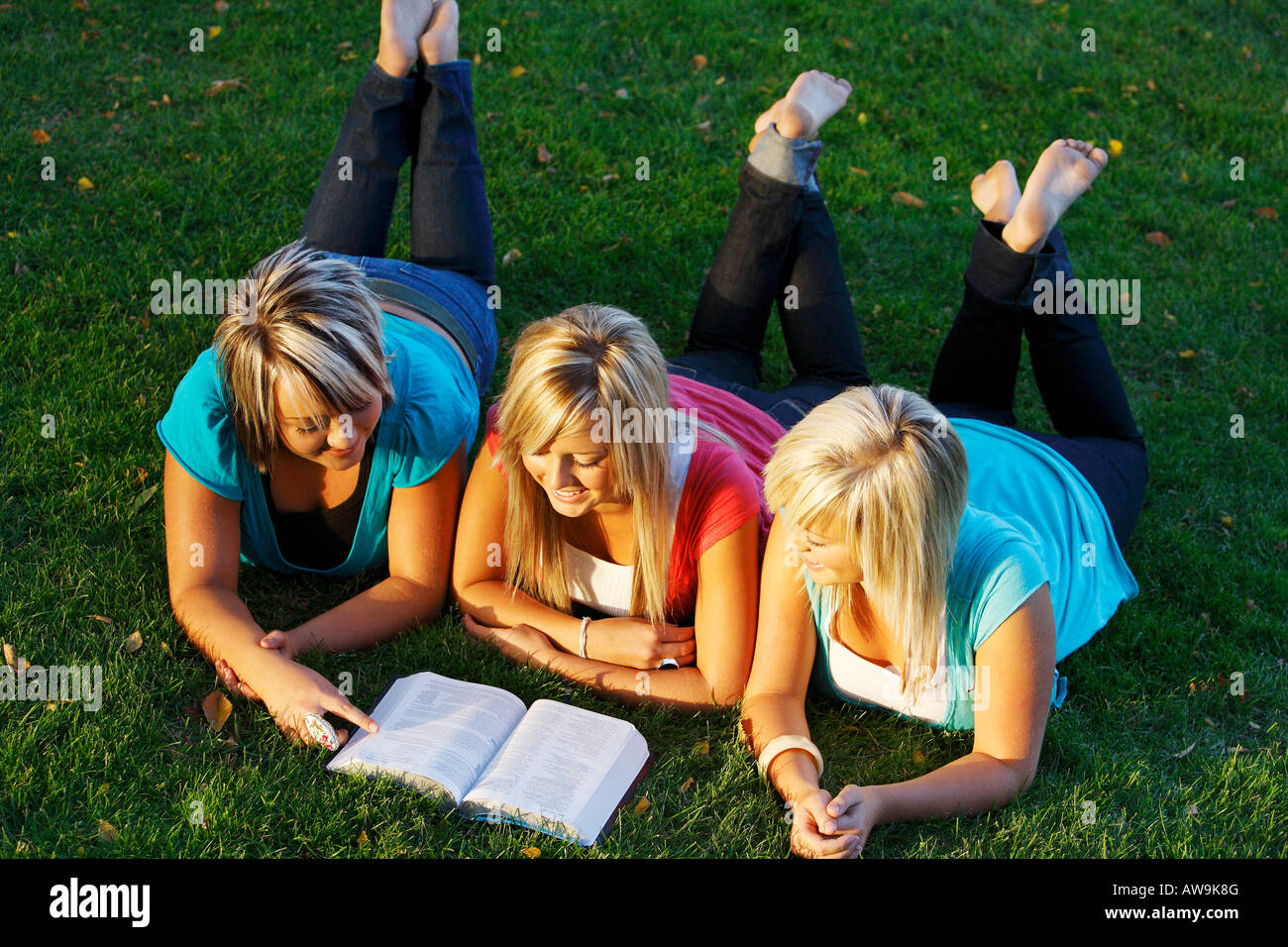 Three girls reading the Bible together Stock Photo - Alamy