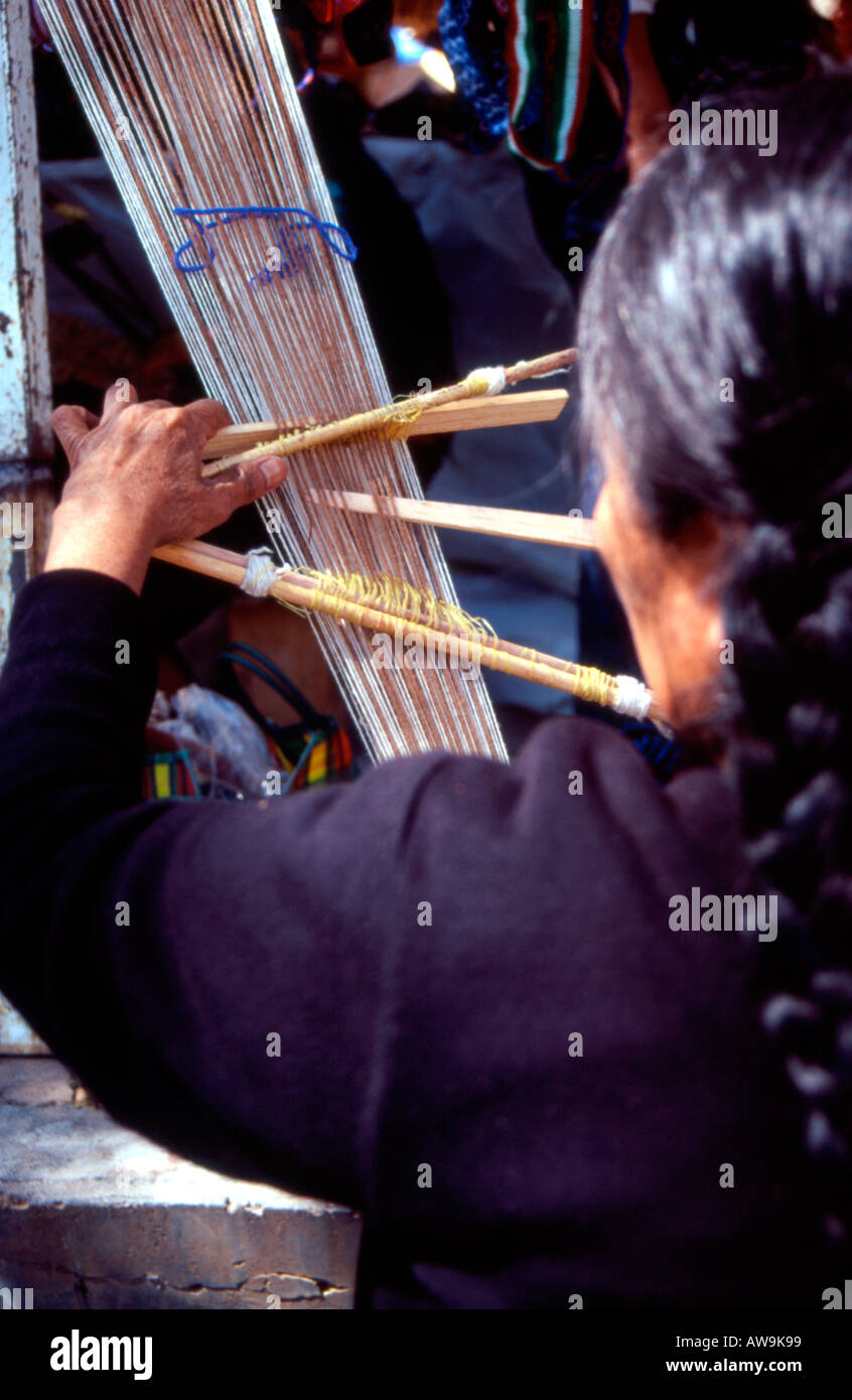 A woman making a belt on the loom in the city of Patzcuaro Michoacan ...