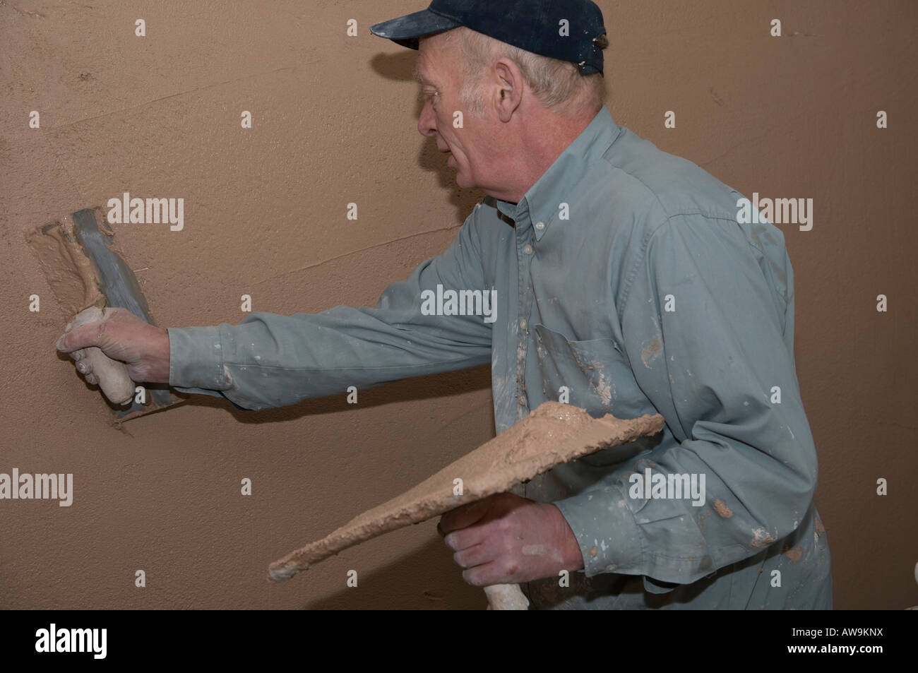 Applying first coat bonding plaster to wall Stock Photo - Alamy