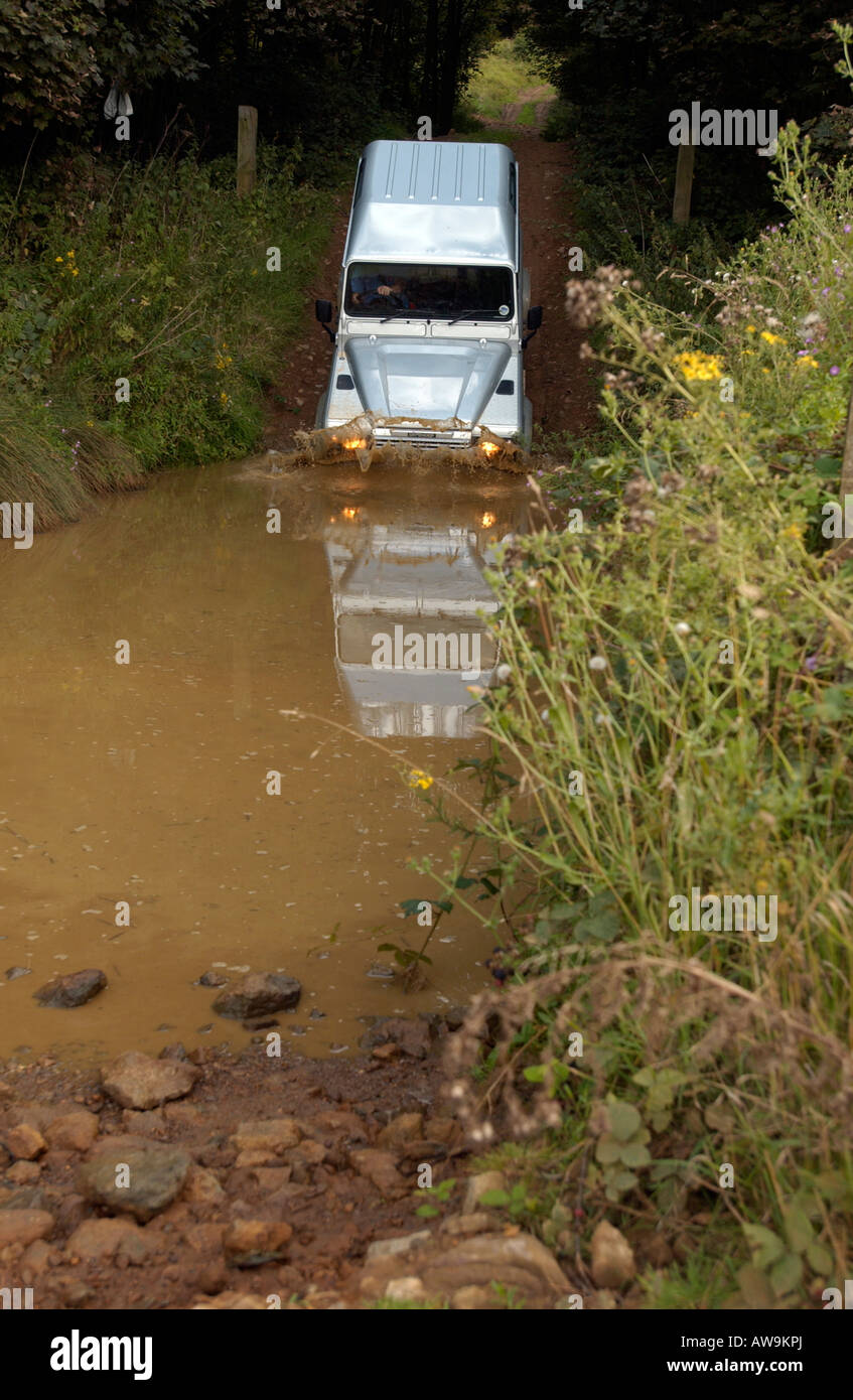Land Rover Defender negotiating a water hazard Stock Photo - Alamy