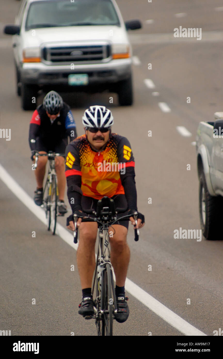 A pair of bicyclists share the road with automobile traffic F1008A2562 ...