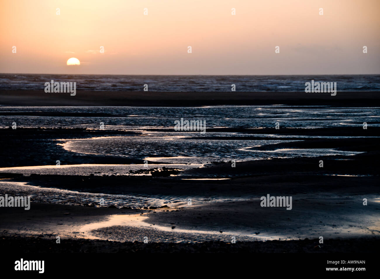 An image of a sunset over the beach infront of the prominade in ...