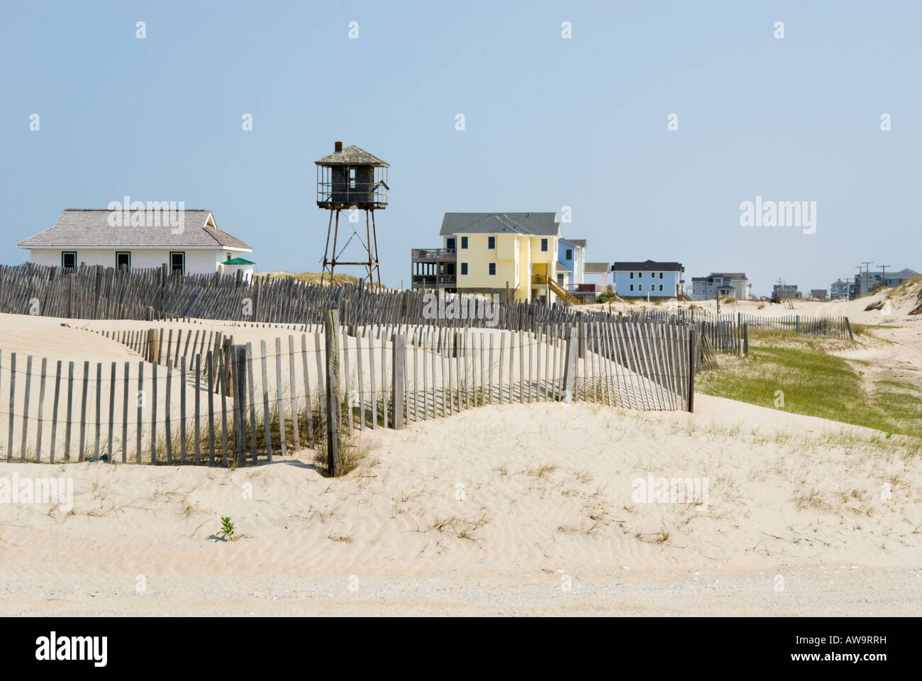 Small town beach houses in sand dunes at the seashore, actual street ...