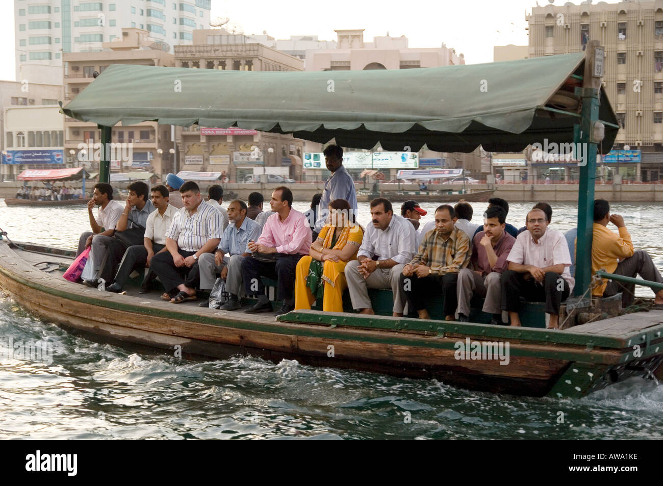 Ferry boat passengers sitting on an abra, being ferried across the ...