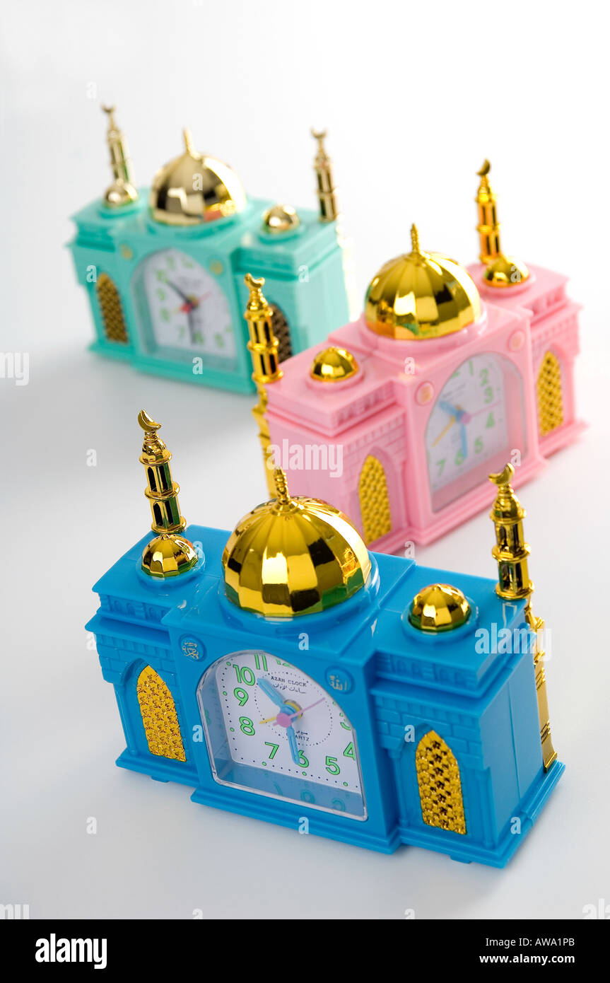 Three plastic alarm clocks in the shape of a mosque. Shot on a white ...