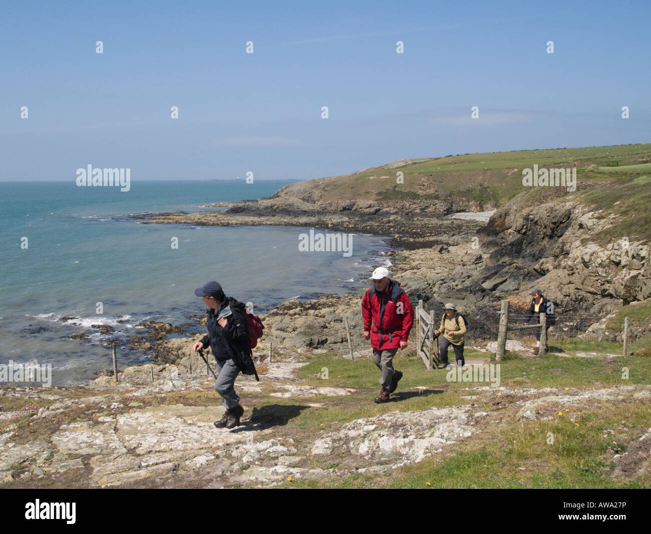 Group of people walking on Anglesey Coastal Path during Walking ...