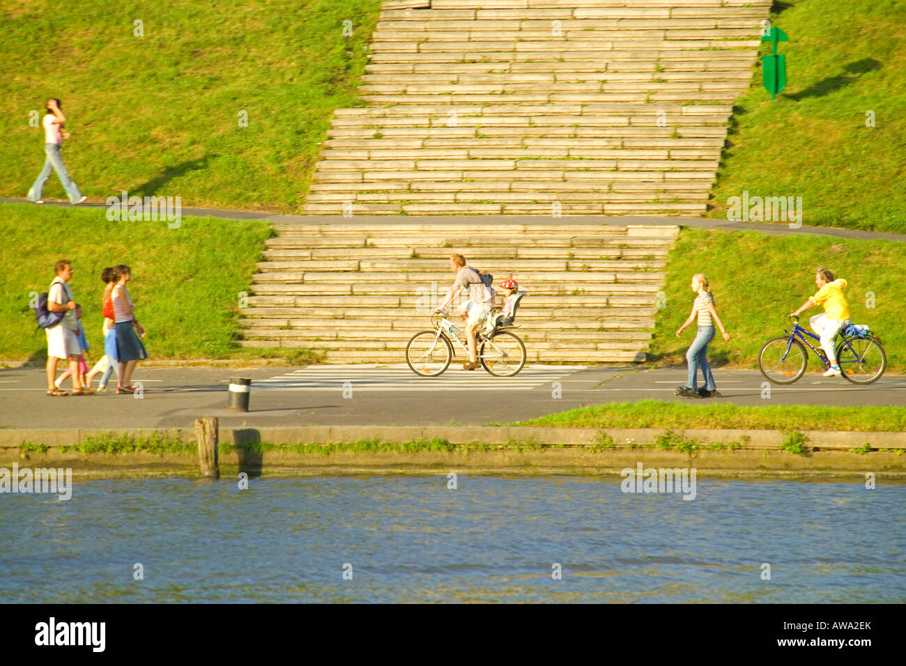 People enjoying the summer sun walking, exercising, riding bicycles ...