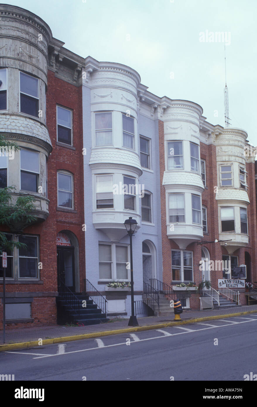 Street of mid 19th century terrace or row town houses in Hudson Upstate ...