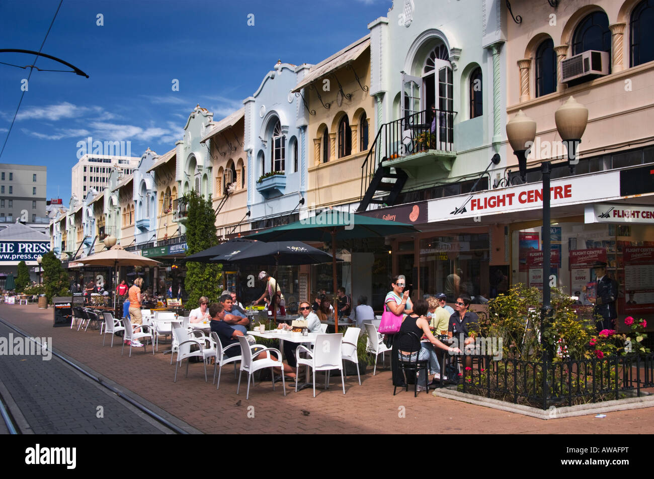 A cafe scene below Spanish Mission style architecture in New Regent ...