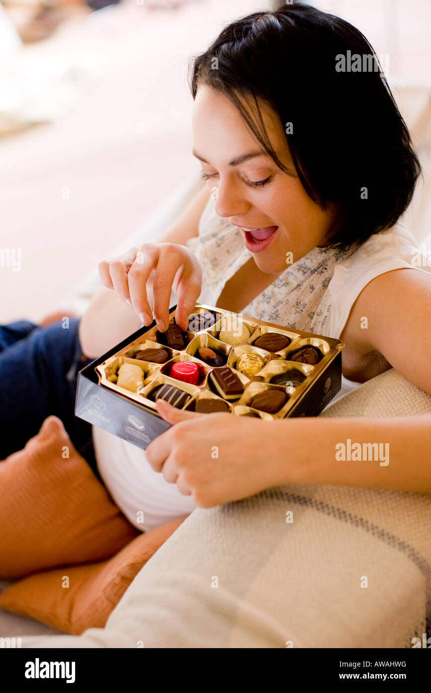 Woman with box of chocolates Stock Photo - Alamy