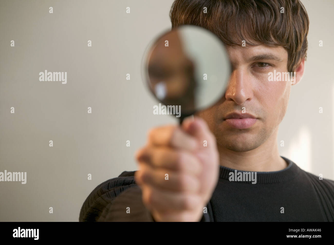 Man with magnifying glass Stock Photo - Alamy