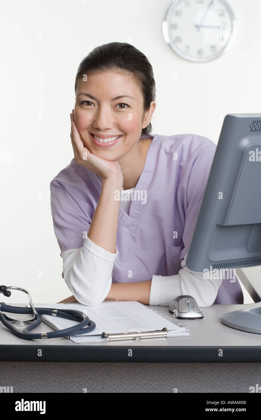 Female doctor leaning on desk hi-res stock photography and images - Alamy
