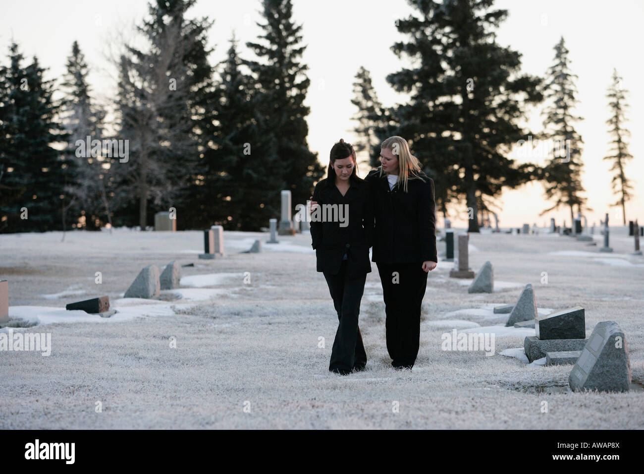 Two woman walking through a cemetery Stock Photo - Alamy