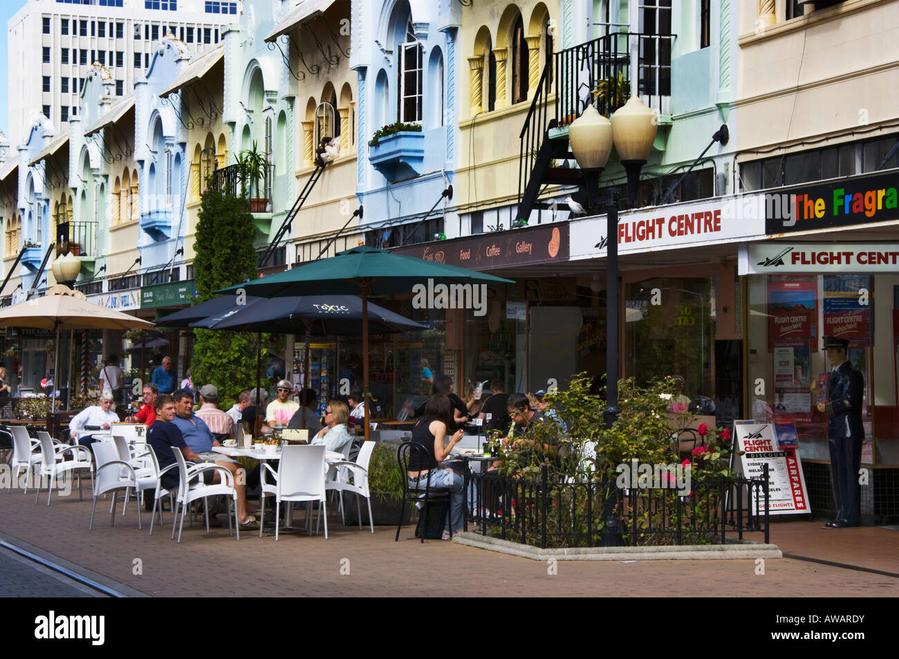 A cafe scene below Spanish Mission style architecture in New Regent ...