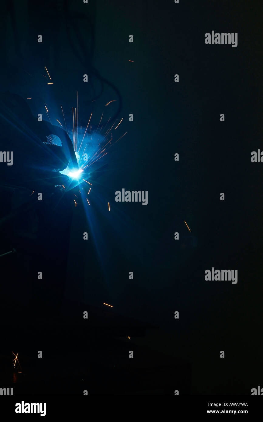Welder at work dark abstract with sparks flying Stock Photo - Alamy