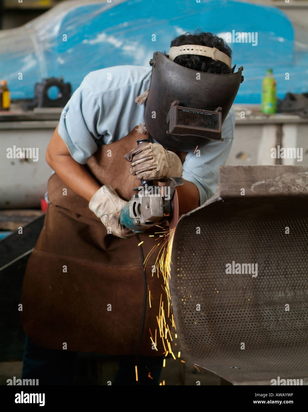 Industrial worker using an angle grinder Stock Photo - Alamy