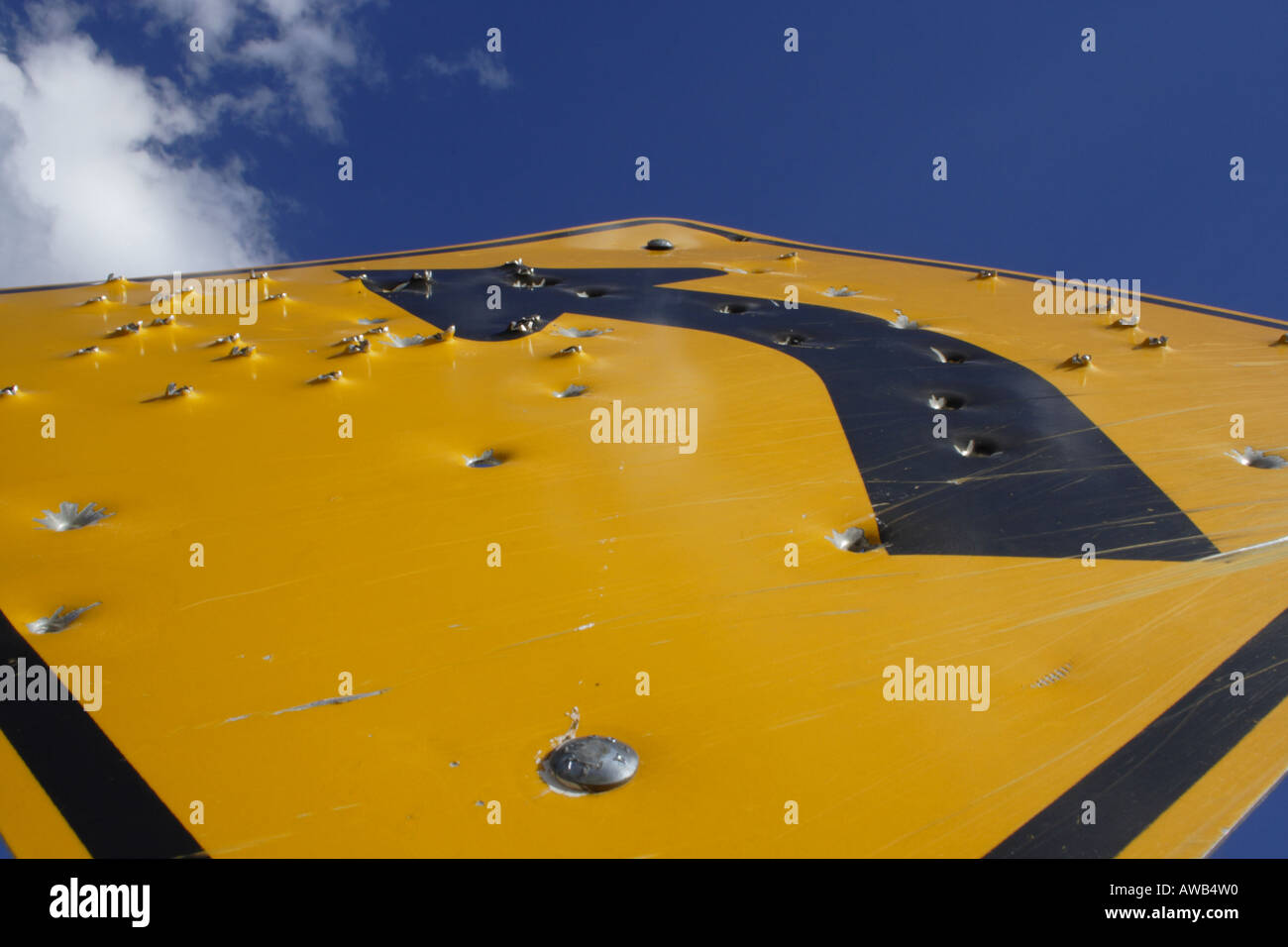 Curve ahead sign takes a beating Stock Photo - Alamy