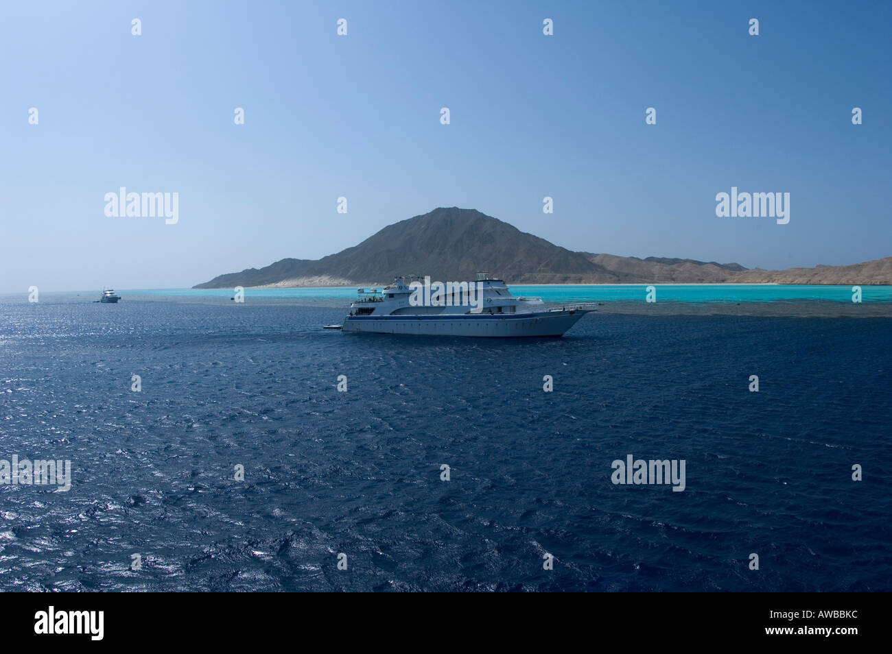 Red Sea liveaboard mored alongside isolated island and reef Stock Photo ...