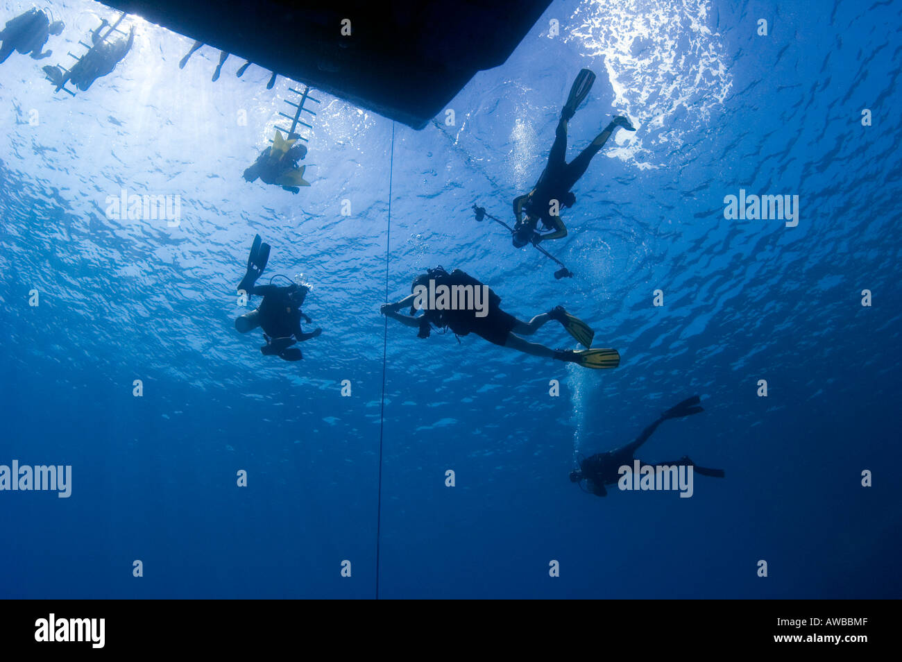 Scuba divers waiting to surface below a liveaboard boat in the Red Sea ...