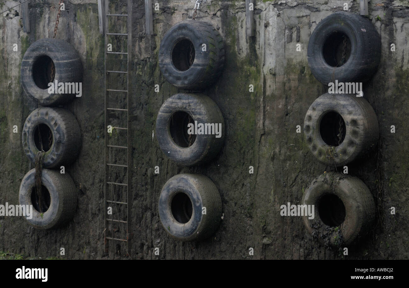 Old lorry tyres used as fenders on the quayside in Mevagissey harbour ...