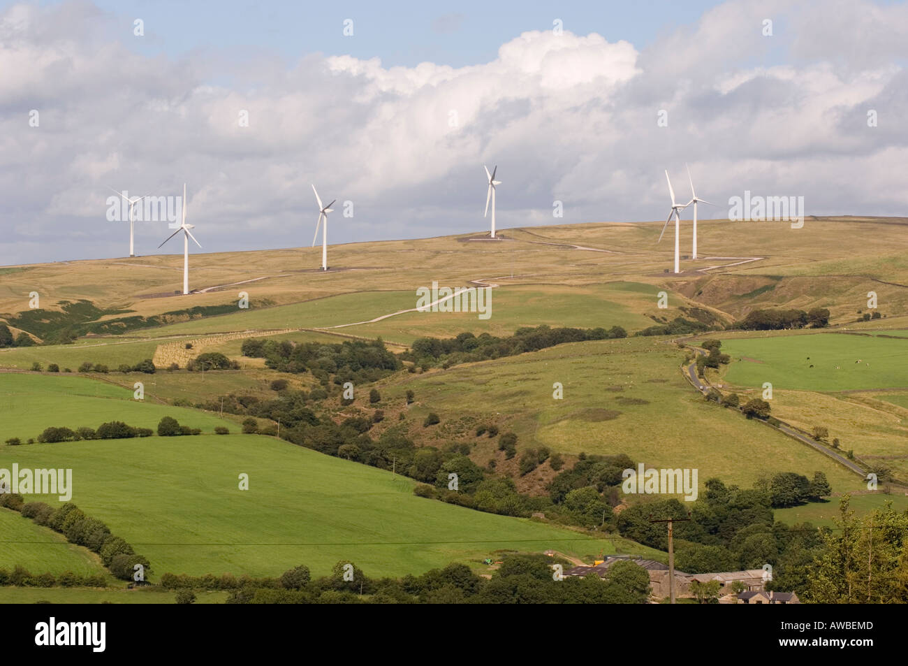Wind turbines on hills above a valley near Caton Lancashire England ...