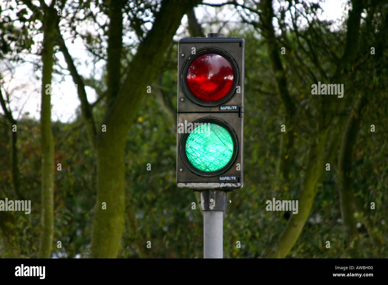 Local red and green traffic light on private road showing green for go ...