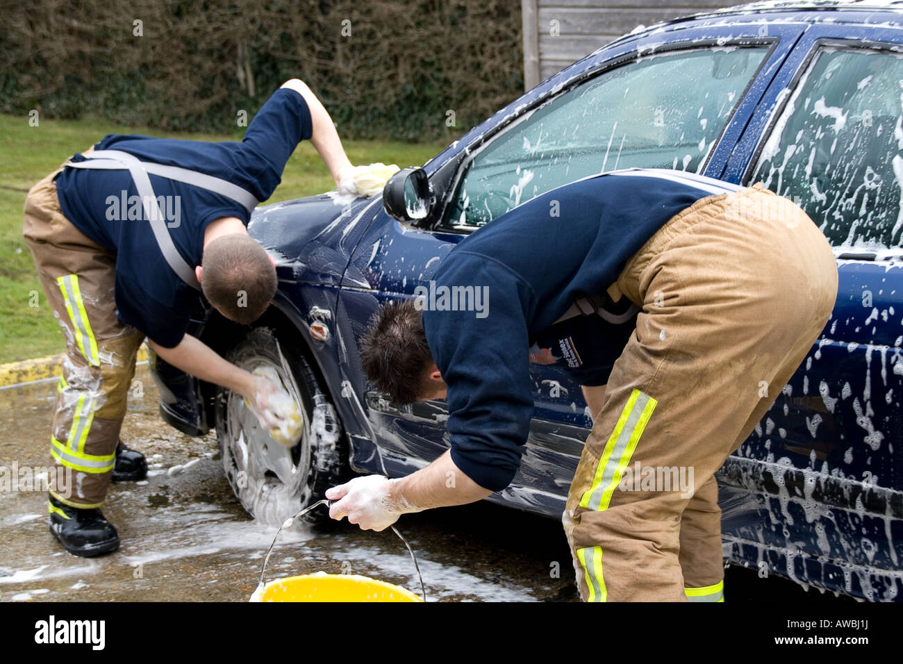 firemen washing car for charity, sussex england uk Stock Photo - Alamy