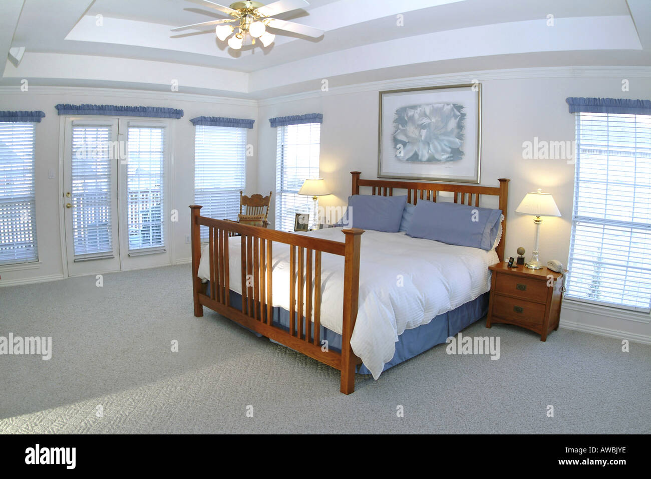Side view of a spacious bed in a cozy bedroom Stock Photo - Alamy